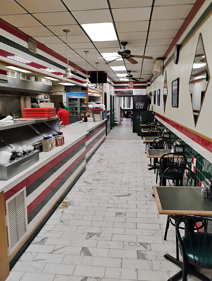 The narrow, tiled corridor of Little Anthony's has witnessed countless pizza pilgrimages—a humble space serving extraordinary food.