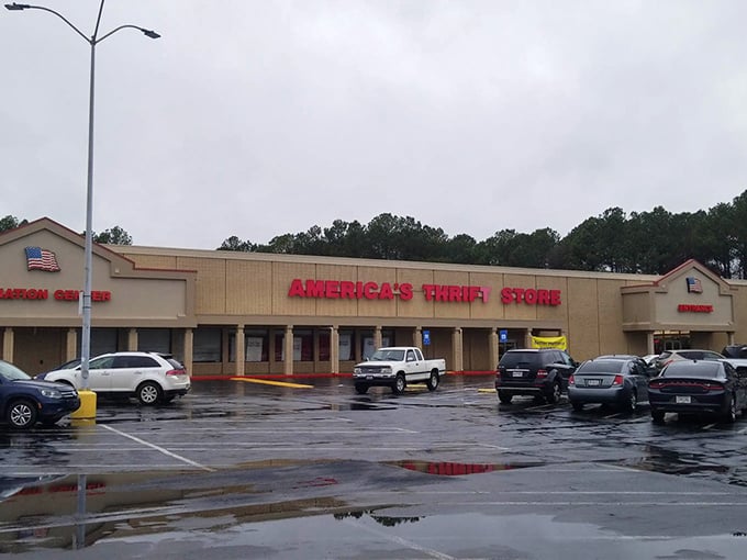 Even on rainy days, America's Thrift Store stands ready, its red signage a beacon of bargain-hunting possibility across the wet parking lot.
