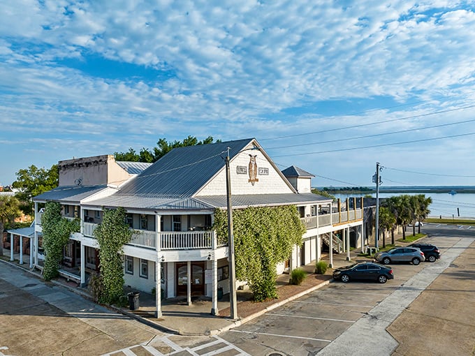 The Owl Café's vine-covered exterior hints at what locals already know—some of the Gulf's finest flavors nest behind those walls.