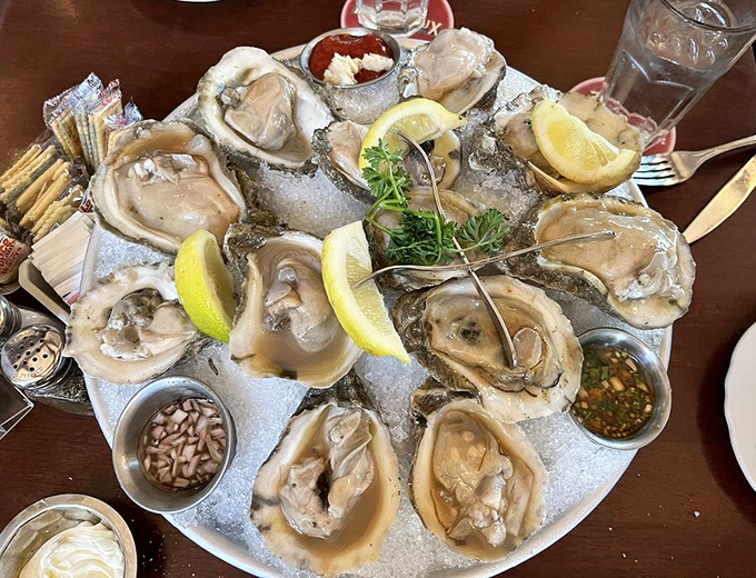 These oysters aren't just served—they're presented like pearls on a silver platter, waiting to slide down your throat with a lemony kiss.