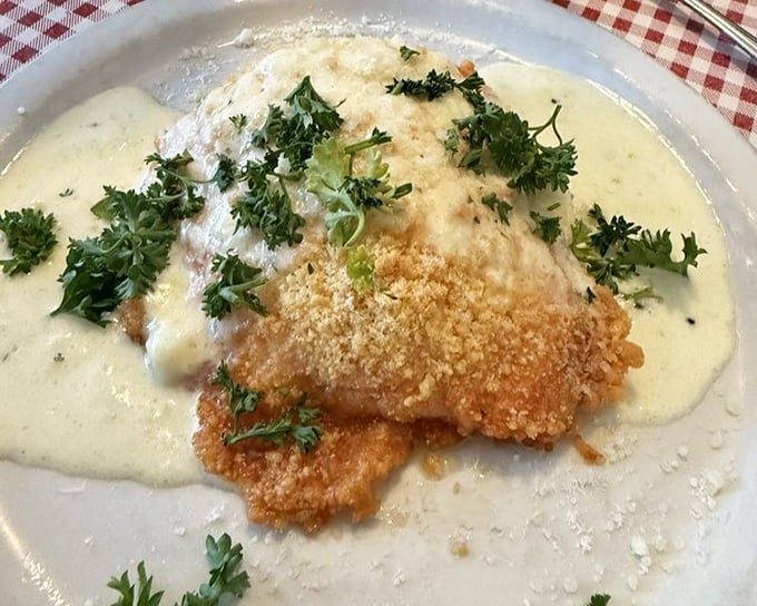 Parmesan-crusted salmon swimming in a sea of creamy sauce. That sprinkle of fresh herbs isn't just garnish – it's the exclamation point.