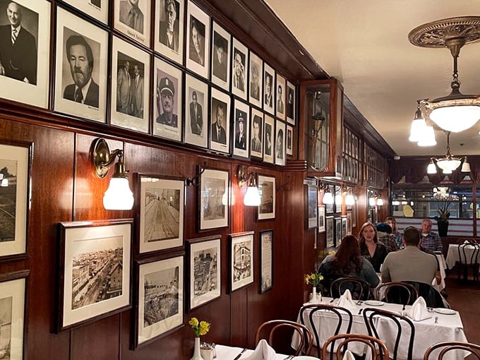 The wall of fame showcases visitors who knew a good thing when they tasted it – history served alongside your steak.