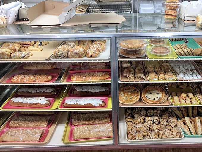 The pastry case reveals layer upon layer of baked treasures, like a delicious archaeological dig through generations of family recipes.