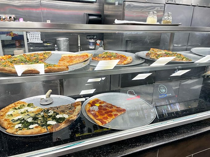 Pizza display cases – the art galleries of the food world. Each pie a masterpiece waiting to be appreciated slice by delicious slice.