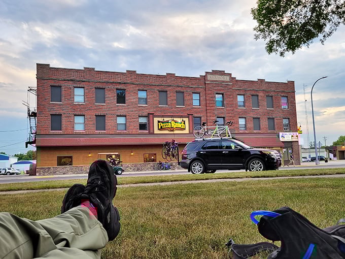 Pizza Ranch occupies a classic brick building where comfort food meets comfort pricing—the tandem bike on display suggests the leisurely pace of life here.