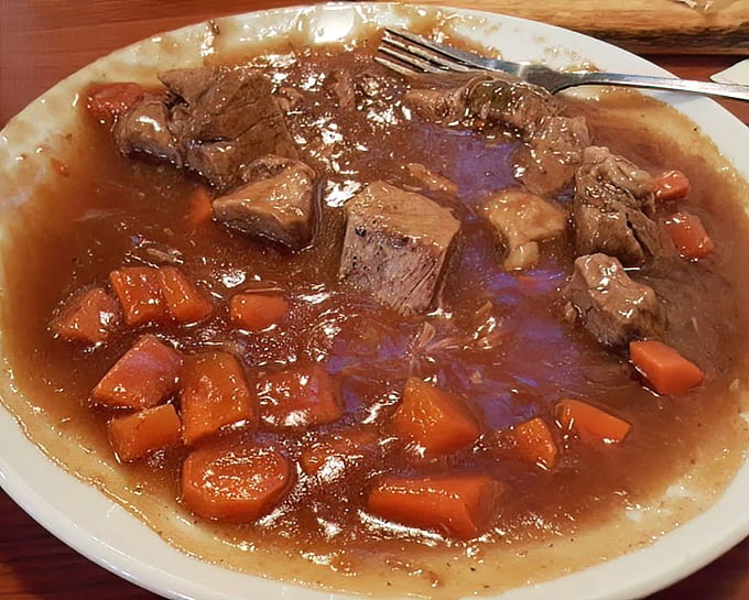 This isn't just stew—it's a slow-simmered masterpiece where beef surrenders completely to become fork-tender morsels swimming in rich gravy.