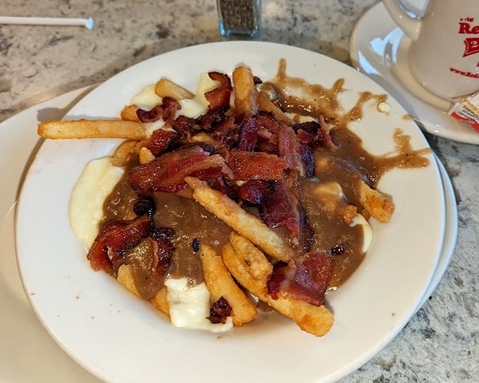 Poutine with bacon – because sometimes good things can become extraordinary with just one simple, porky addition.