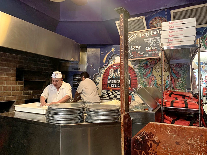 The preparation area reveals the heart of the operation – coal-fired ovens that have been turning out perfect pies since Herbert Hoover was president.