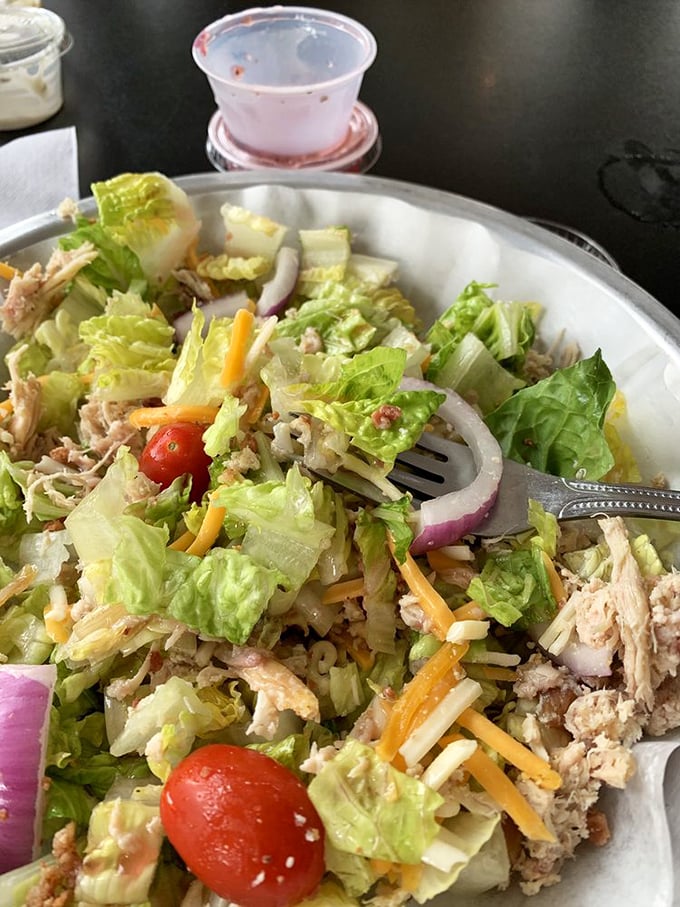 A salad that doesn't apologize for being healthy, because it's loaded with enough smoked chicken to earn its barbecue credentials. Balance achieved.