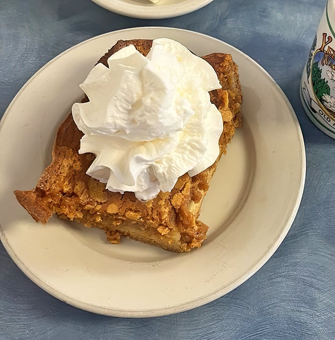 This isn't just dessert masquerading as breakfast – it's pumpkin bread pudding crowned with whipped cream that makes you question why we have food rules at all.