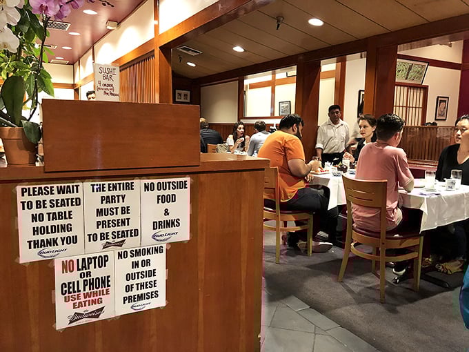 House rules posted without apology—no cell phones, no outside food—because some experiences deserve your complete, undivided attention.