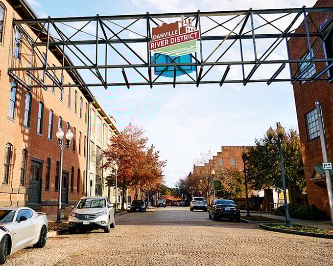 The River District sign spans above like a gateway to possibility, welcoming visitors to Danville's revitalized heart.
