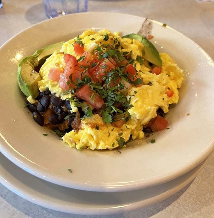 The Santa Fe Scramble brings southwestern flair to your morning—a fiesta of eggs, avocado, and black beans that wakes up your taste buds.