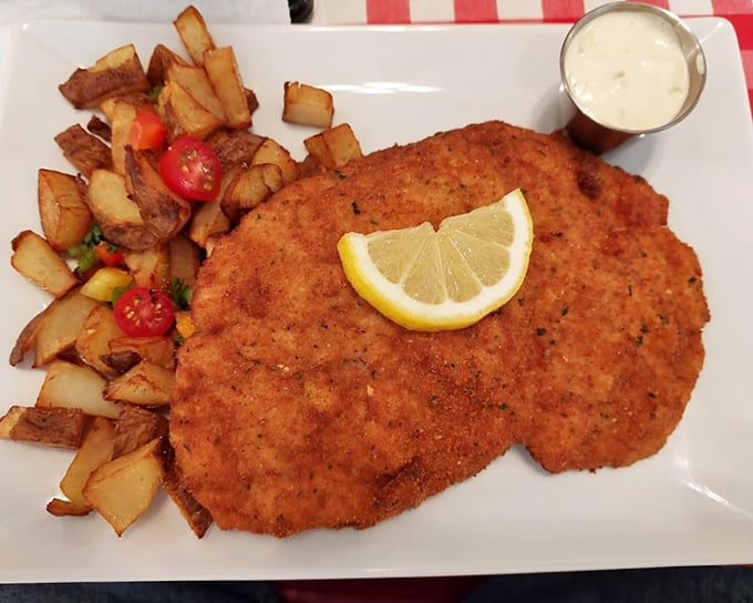 This isn't just schnitzel—it's a golden-brown masterpiece of crispy perfection that makes your fork the luckiest utensil at the table.