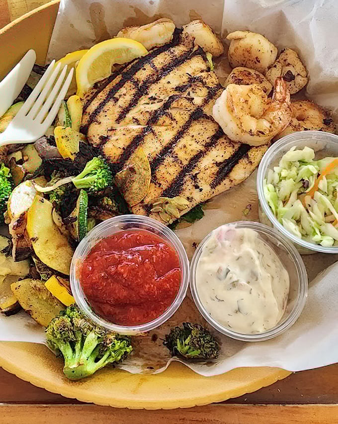 A seafood platter that tells the story of the Gulf in one bite—grilled fish, plump shrimp, and vegetables that actually taste like vegetables.