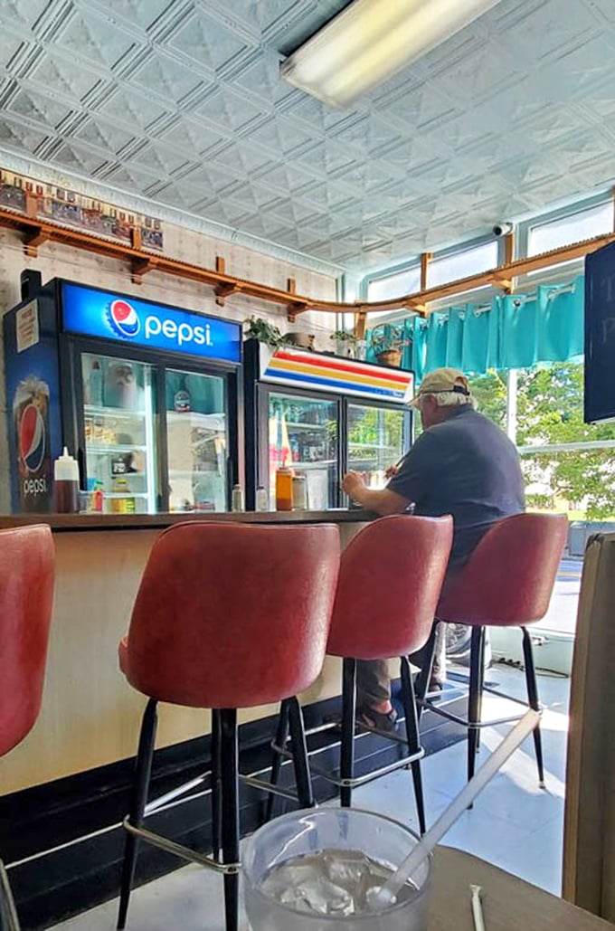 Counter seating with pink swivel chairs offers front-row views of downtown Shepherdstown through those big windows.