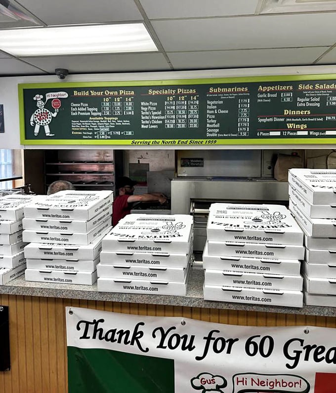 The mountain of pizza boxes awaiting hungry customers tells you everything—this isn't a place people try once for Instagram. It's where they return weekly.