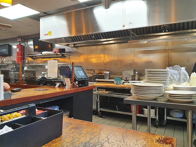 The heart of operations – where plates wait for their starring role and the rhythm of order tickets keeps the diner's pulse beating.