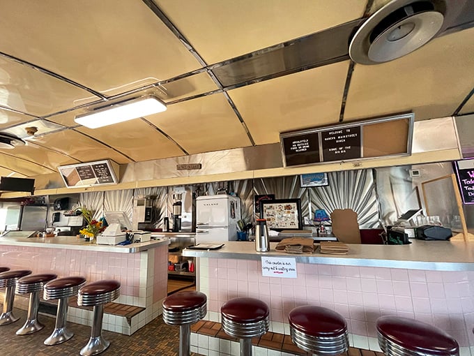 The heart of the diner operation – where orders are called, coffee is poured, and the symphony of comfort food is conducted with practiced precision.