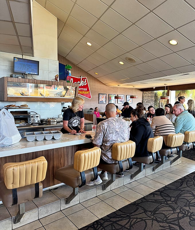 Morning rhythms at the counter—coffee poured, orders called, and the beautiful choreography of a diner that knows its purpose.
