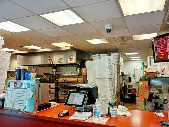 A glimpse behind the curtain—where pizza magic happens. Those stacked boxes aren't just containers; they're vessels of joy awaiting deployment to hungry patrons.