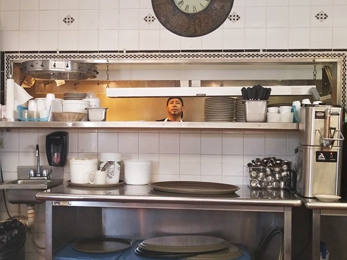 The kitchen pass – that sacred portal where orders transform from ticket to plate. Somewhere behind that counter, pancake magic is happening. 