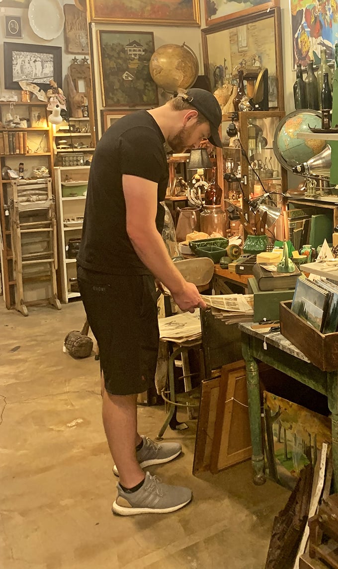 The modern treasure hunter at work. Notice the focused concentration—that's the face of someone who just spotted the perfect vintage find.