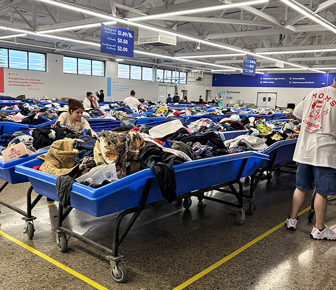 The blue bin battlefield where thrift warriors strategize their approach. Notice the focused determination on every face.