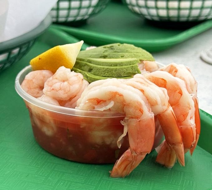 Plump shrimp cocktail with avocado – sea-sweet protein arranged like a bouquet around creamy green gold. Nature's perfect appetizer in plastic perfection.