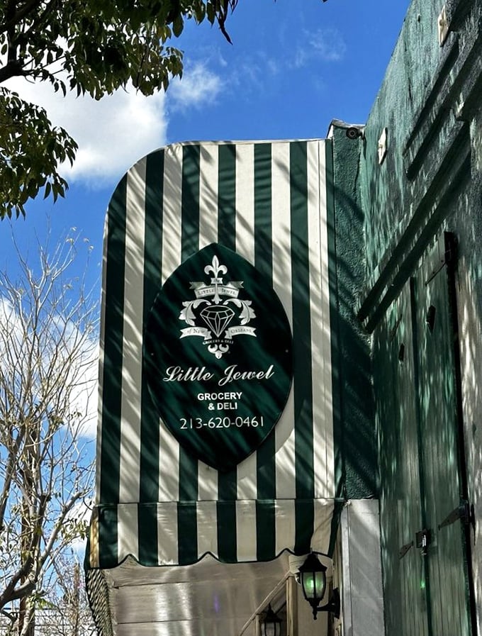 The Little Jewel's elegant signage promises treasures within—a fleur-de-lis emblem standing guard over authentic Cajun delights in the heart of Los Angeles.