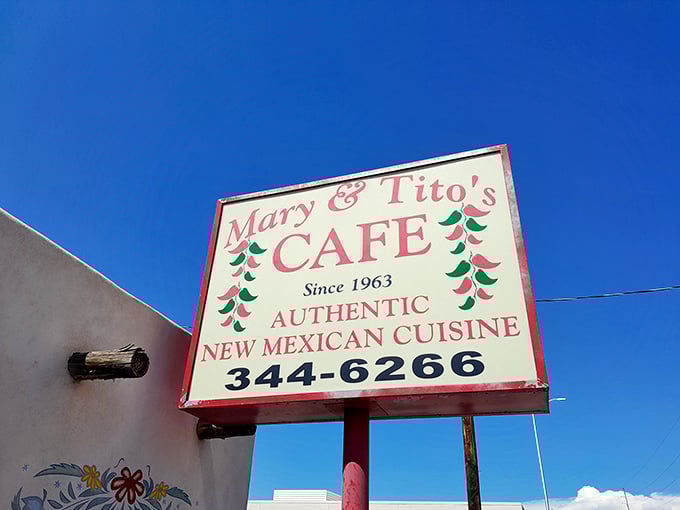 The sign stands against the brilliant New Mexico sky like a beacon of hope for travelers seeking the real deal in chile country.