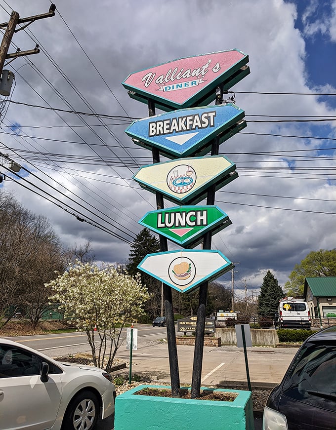 The roadside sign that beckons hungry travelers like a colorful lighthouse guiding ships to the safe harbor of breakfast.
