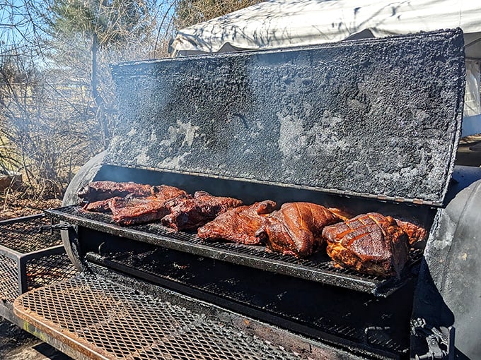 Where the magic begins—meat meeting smoke in the great outdoors. This weathered smoker has stories to tell, all of them delicious.