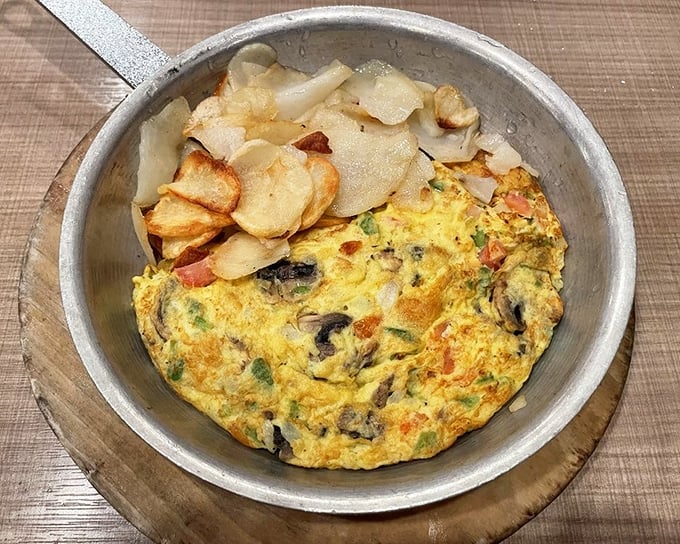 This veggie-packed omelet isn't just breakfast—it's practically a garden tour served in a skillet with crispy potatoes as your tour guide.