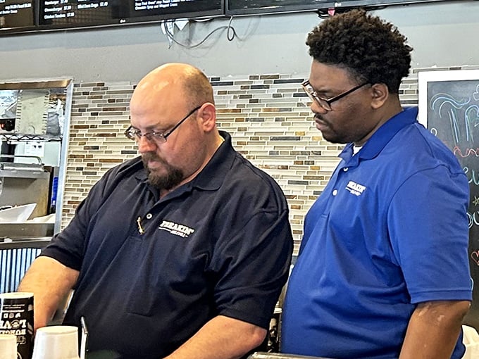 Dedication in action: staff members focused on crafting your meal with the concentration usually reserved for defusing bombs or brain surgery.