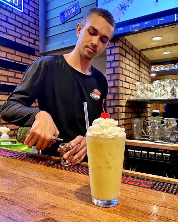 Behind every great dessert is someone crafting it with care – this towering whipped cream creation promises a sweet finale.
