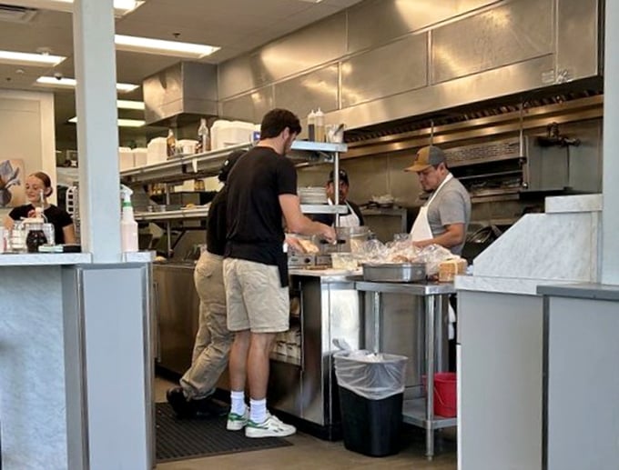 The kitchen crew works with the precision of a synchronized swim team—except they're creating omelets instead of water formations.