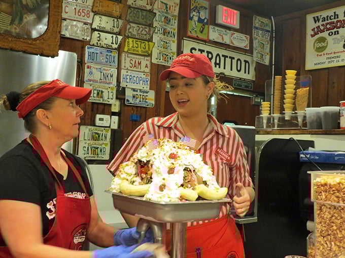 The red-striped uniforms aren't just cute—they're warning signs that your diet is about to face serious temptation. These servers are happiness dealers.