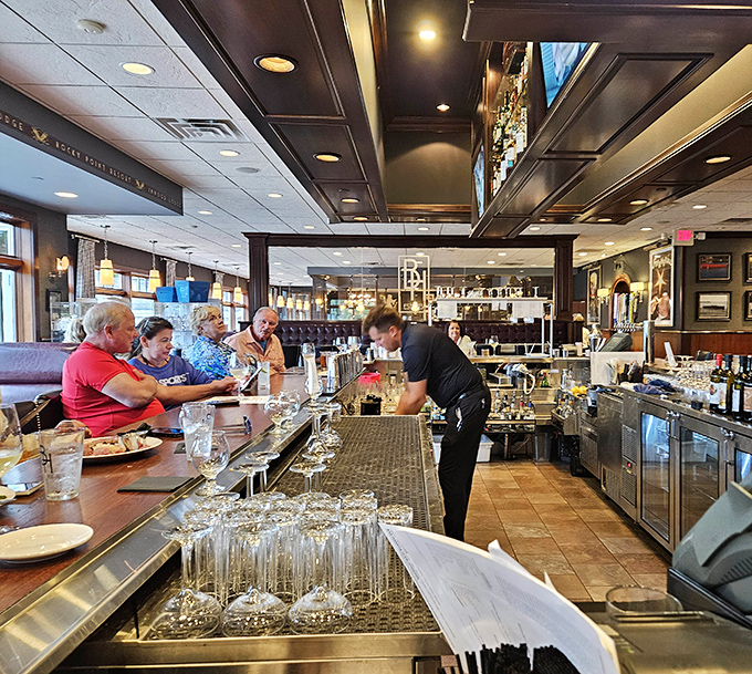 Staff attending to patrons at the bar—the unsung heroes who know exactly when you need another round without being asked.