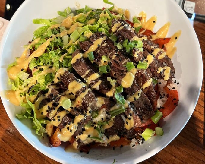 A bowl where steak cubes reign supreme over fresh vegetables, proving that surf isn't the only worthy turf in a seafood joint.