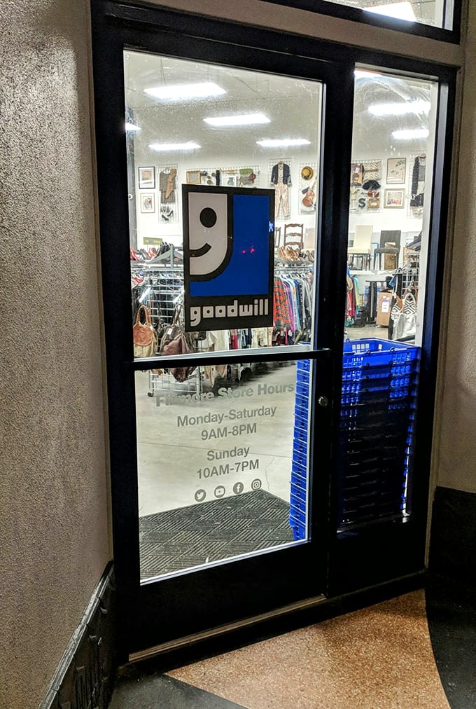 The welcoming entrance displays store hours and the smiling Goodwill logo—a portal to affordable possibilities seven days a week.