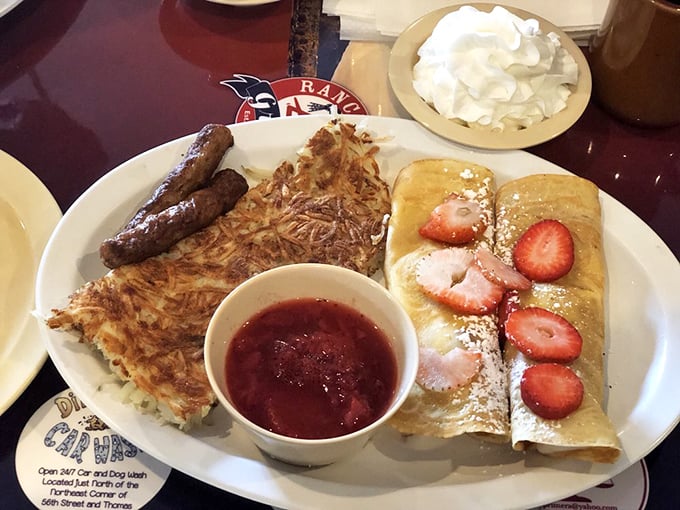 These crepes aren't just filled with strawberries—they're wearing them like jewelry, with a side of hash browns for balance.