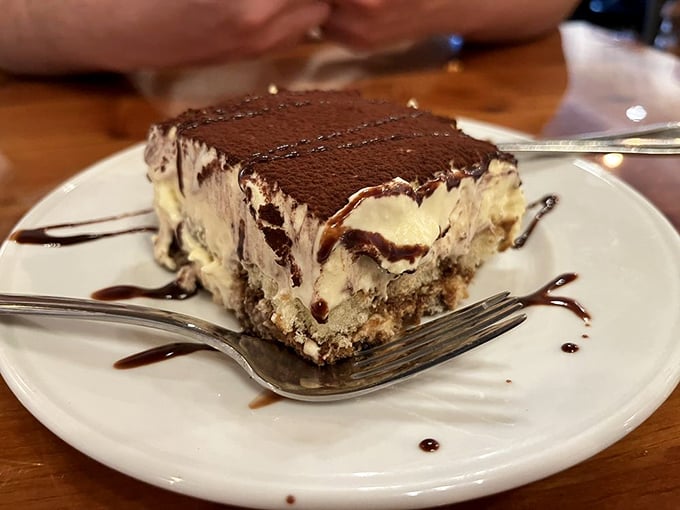 This isn't just tiramisu—it's a stratified masterpiece of coffee-soaked bliss that makes you wonder why you ever waste calories on lesser desserts.