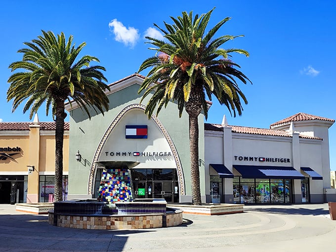 Tommy Hilfiger's distinctive arched entrance flanked by palm trees – architectural proof that shopping is indeed a religious experience.