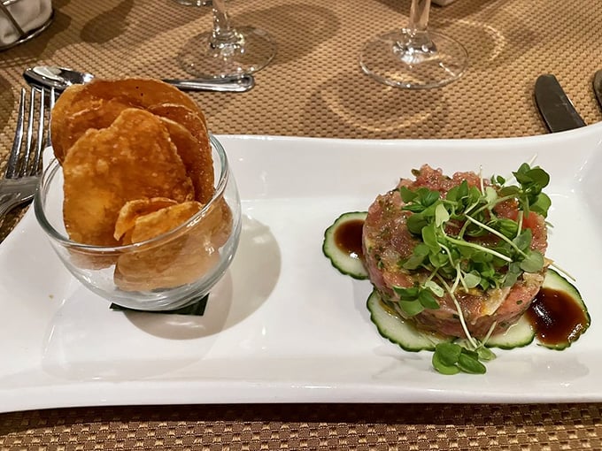 Tuna tartare presented with architectural precision, accompanied by house-made potato chips—a sophisticated starter that sets the tone for what's to come.