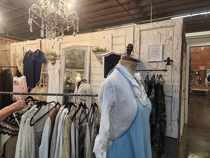 Vintage clothing displayed under crystal chandeliers—because even second-hand deserves first-class treatment. That mannequin has better posture than all of us.
