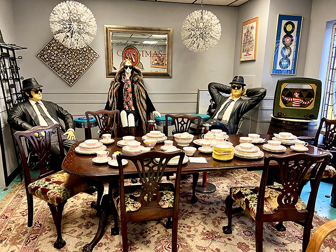 The Blues Brothers meet fine dining in this surreal tableau. Sunglasses indoors never looked so cool – or so eerily watchful over dinner.