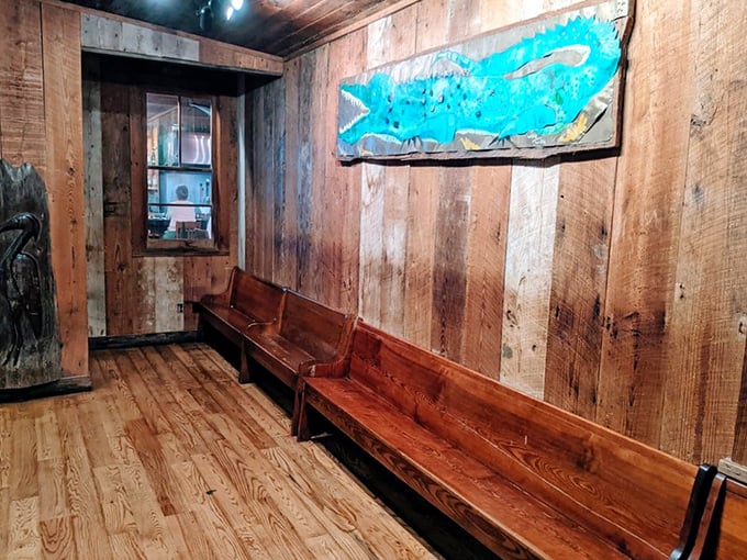 The waiting area's wooden benches and blue fish art – where anticipation builds and you'll swear you can already taste the seafood.