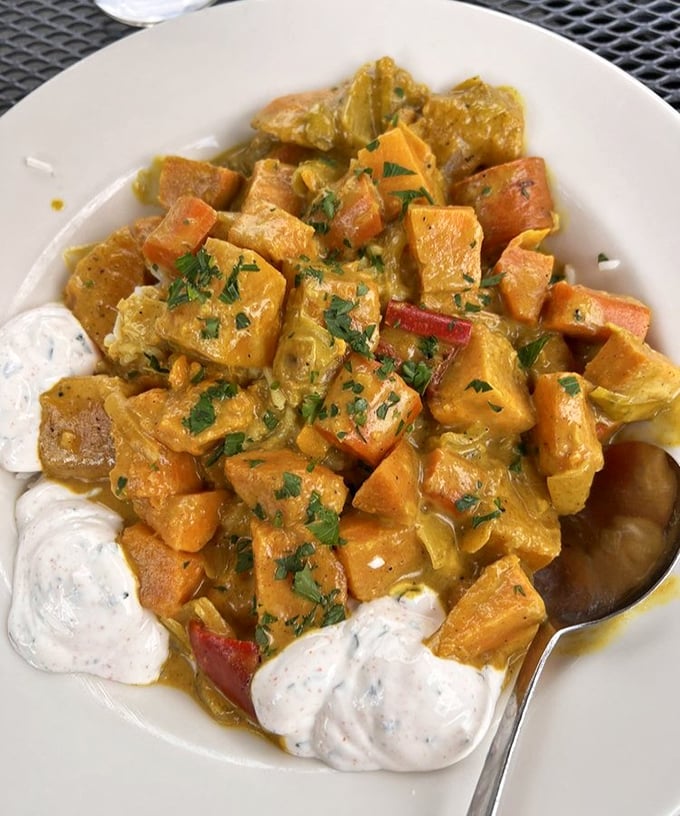 The coconut curry transforms sweet potatoes and vegetables into a vibrant, aromatic journey that makes you wonder why you'd ever need meat.