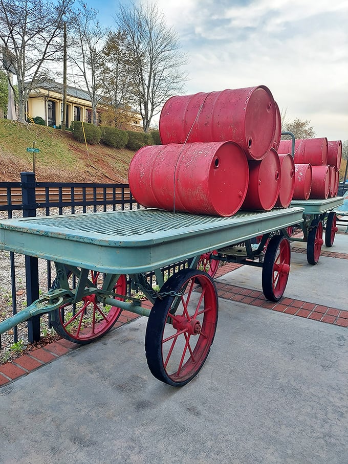 These vintage red barrels stacked on an antique baggage cart create an unintentional art installation celebrating Cornelia's signature hue.